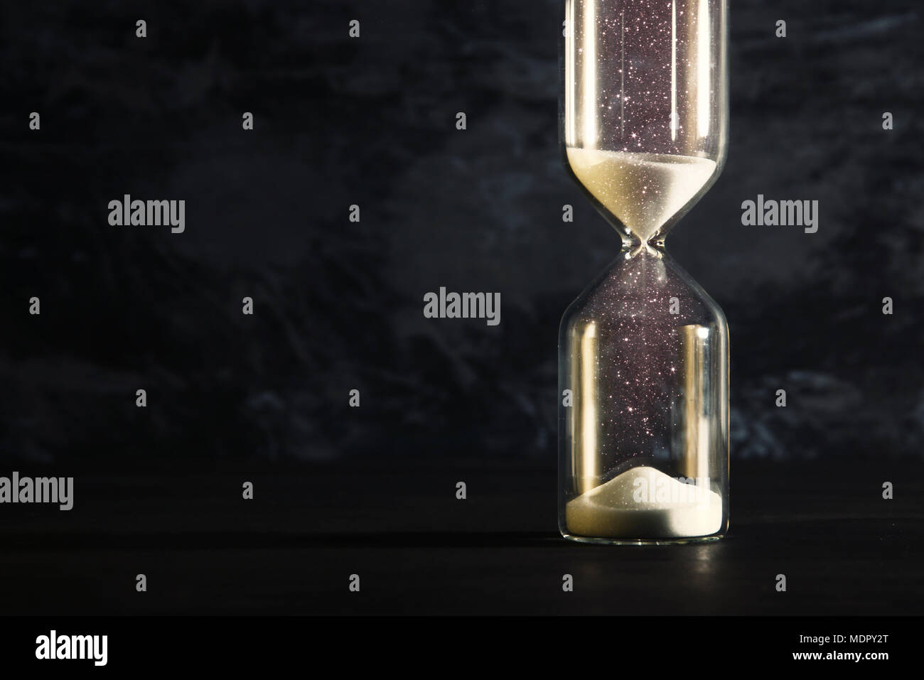 Image of hourglass as time passing concept over black background for ...