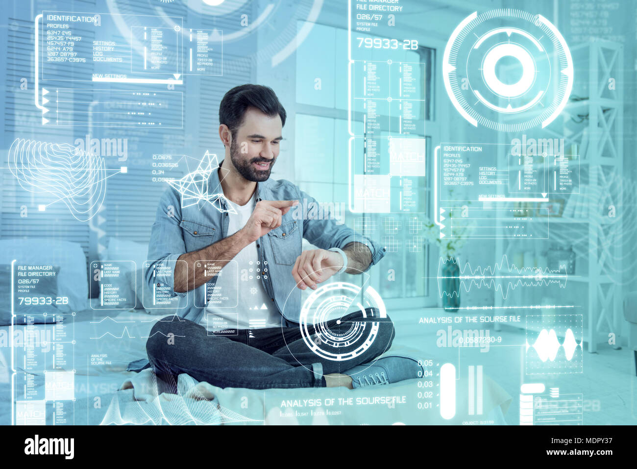 Progressive man looking interested while using a smart watch Stock ...