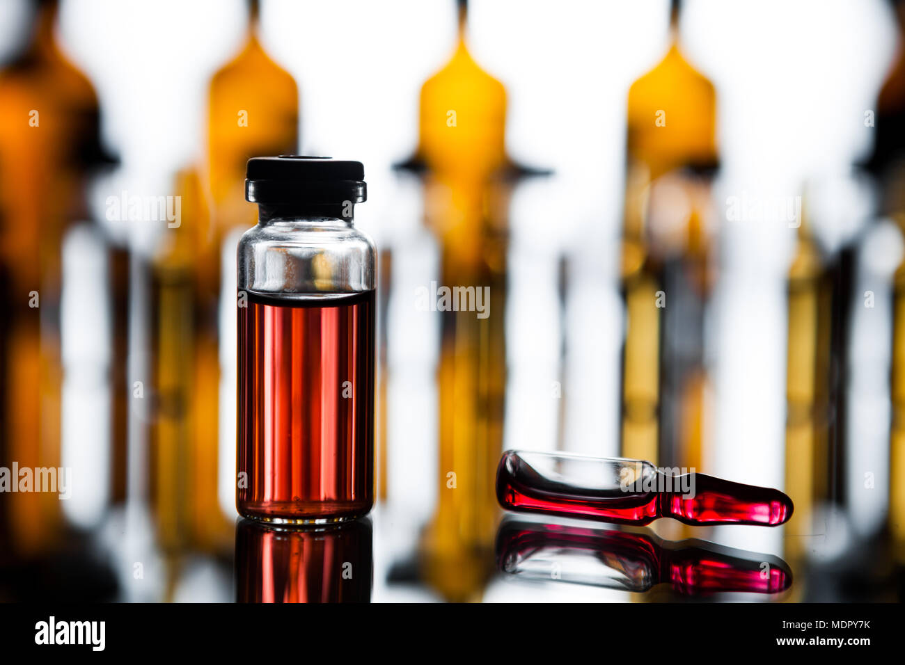 Production of medicines. lot of ampoules on light background. Group of ...