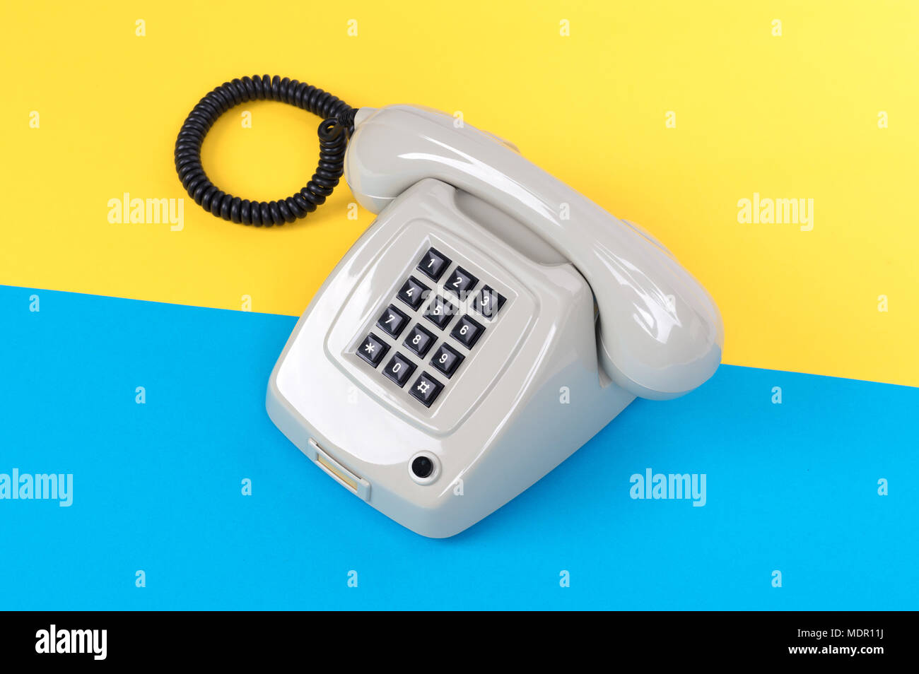 Vintage grey telephone with a colorful background Stock Photo - Alamy