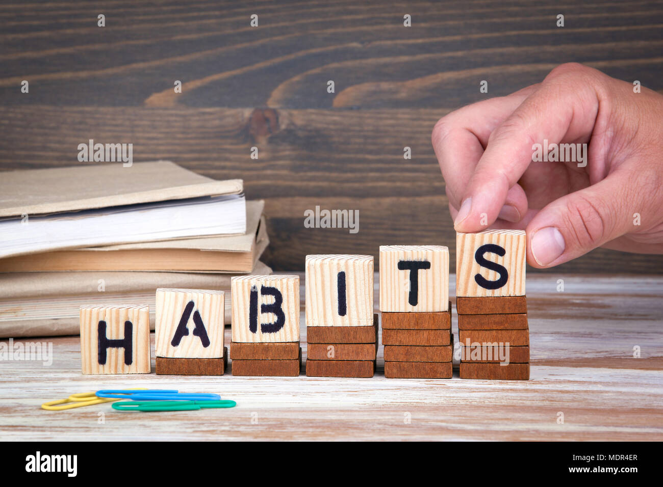 Habits concept. Wooden letters on the office desk, informative and ...