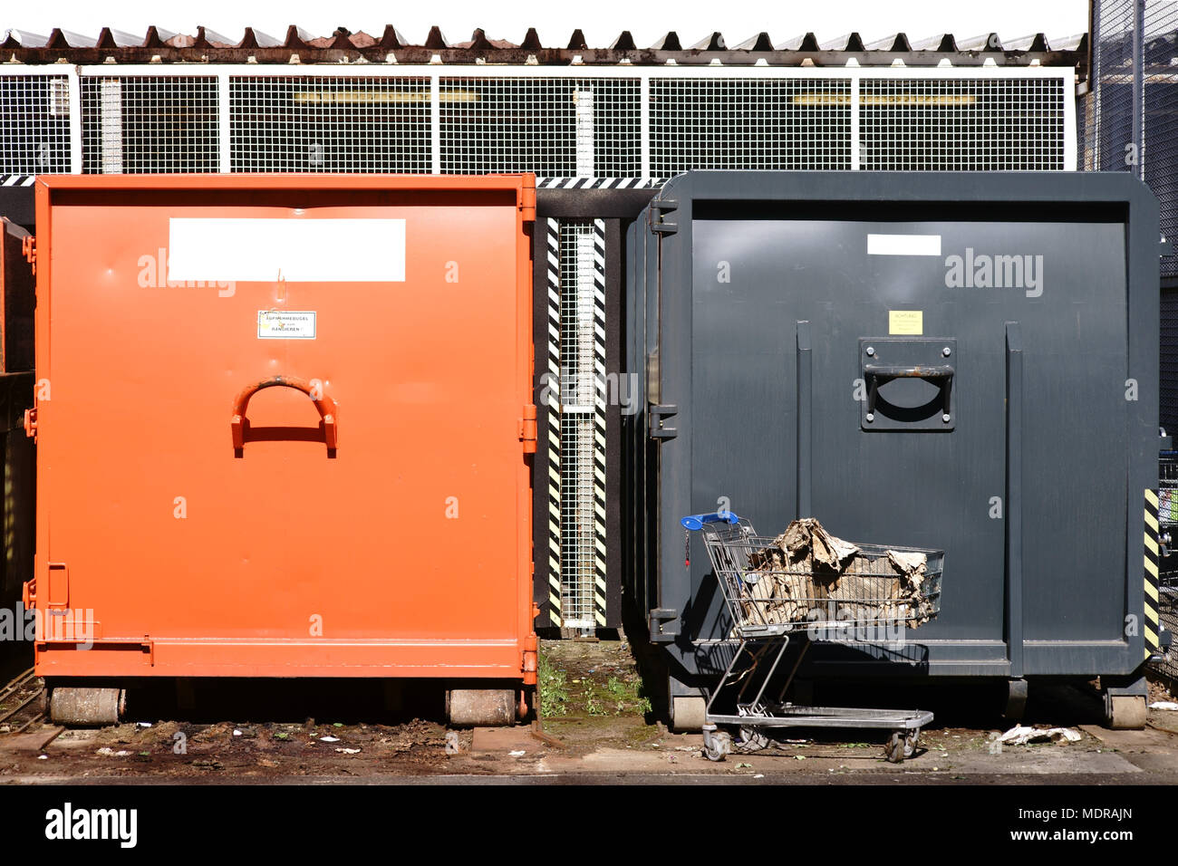 Large waste containers in the backyard of a shopping center with ...