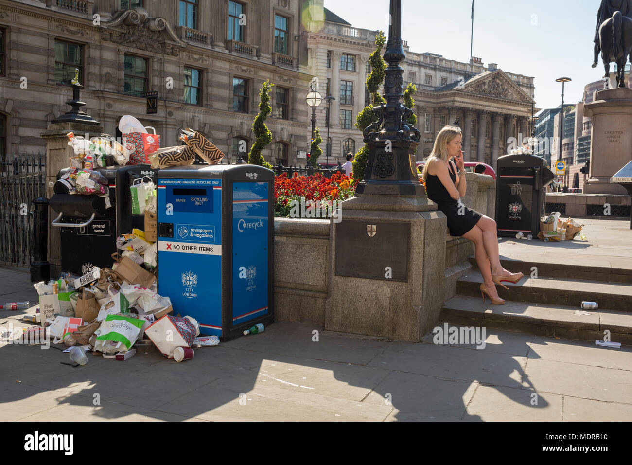 Untypical overflowing rubbish and litter collects over bins and ...