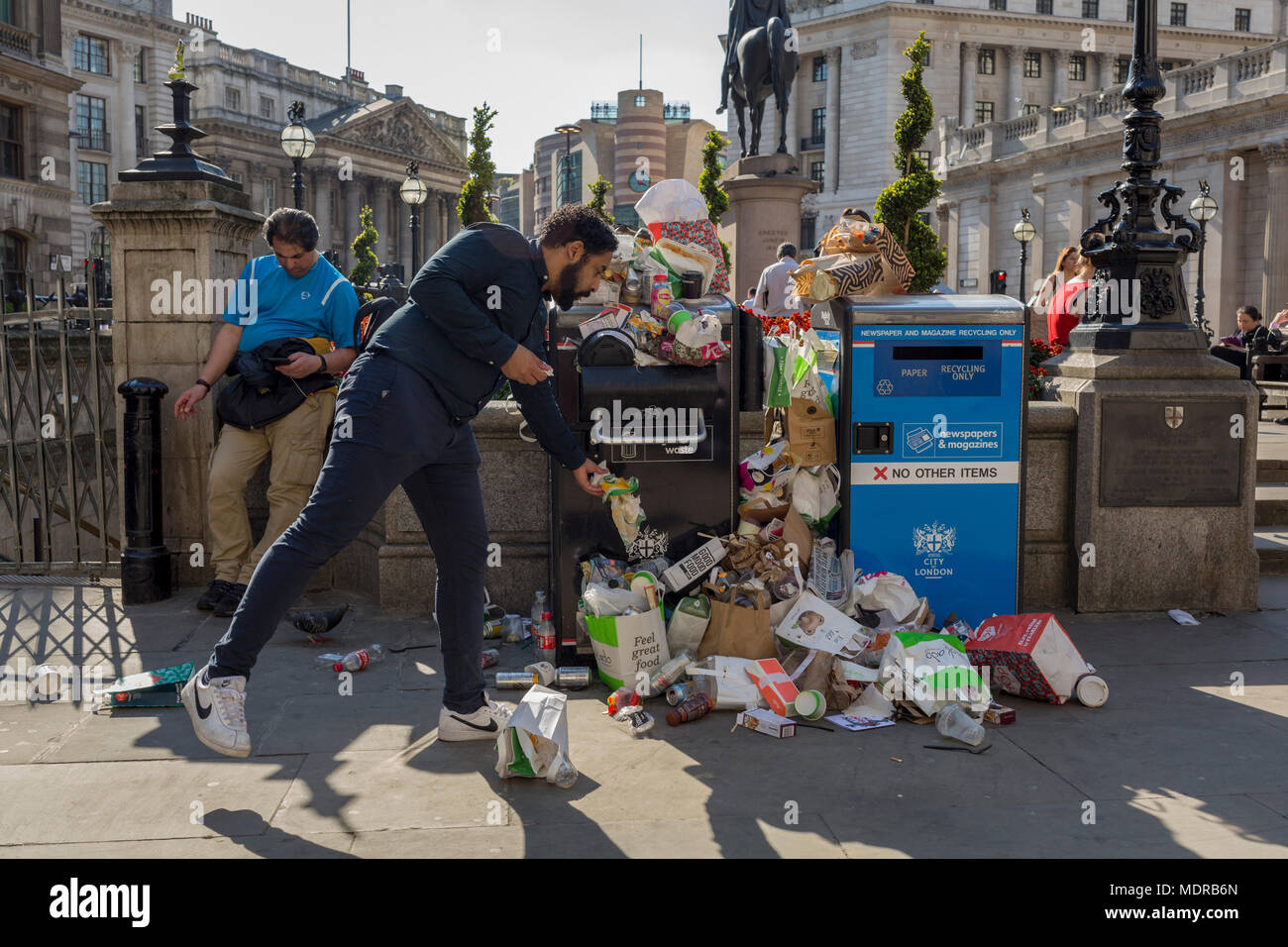 Untypical overflowing rubbish and litter collects over bins and ...