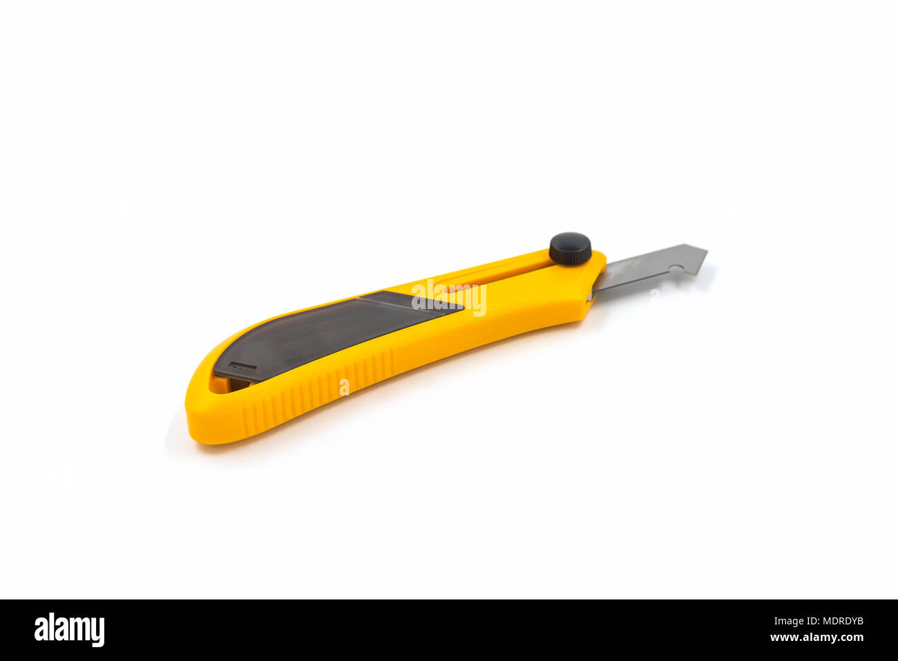 Yellow plastic and laminate cutter knife on white background Stock ...