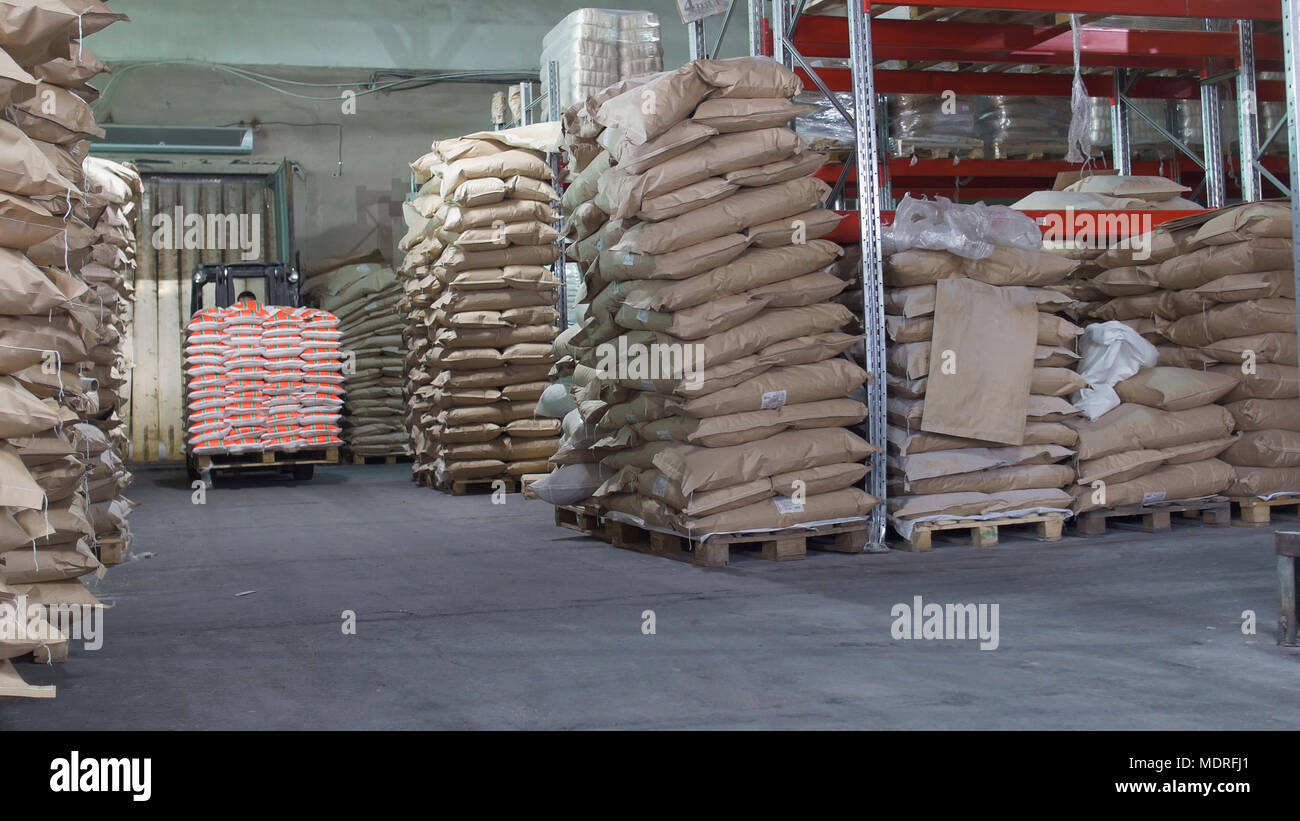 Red loaders transport pallet with boxes on industrial warehouse Stock ...