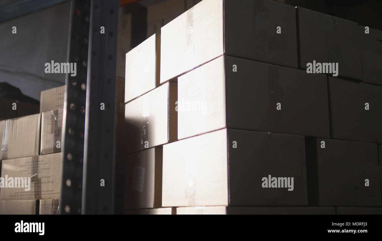Cardboard boxes inside a large warehouse Stock Photo - Alamy