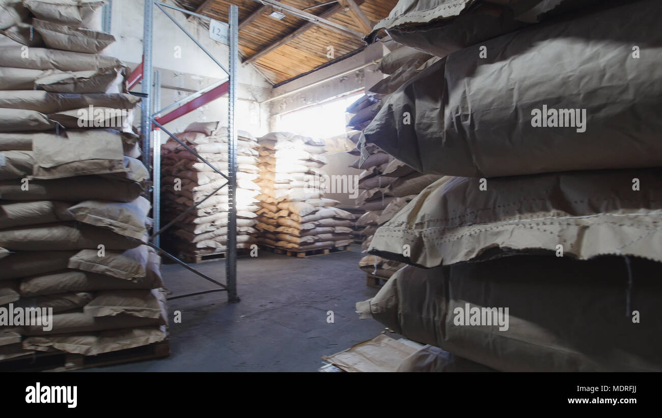 Working warehouse - loaders moves boxes on industrial Stock Photo - Alamy