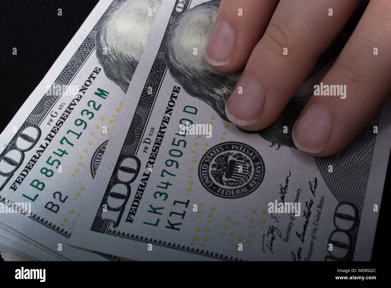Hand holding American dollar banknotes isolated on white background ...