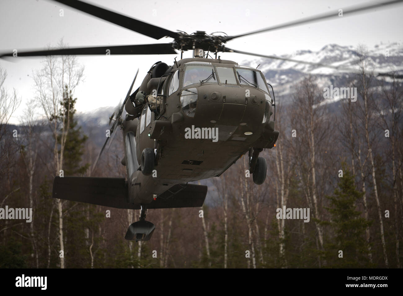 An Alaska Army National Guard UH-60L lifts off with medics from the ...
