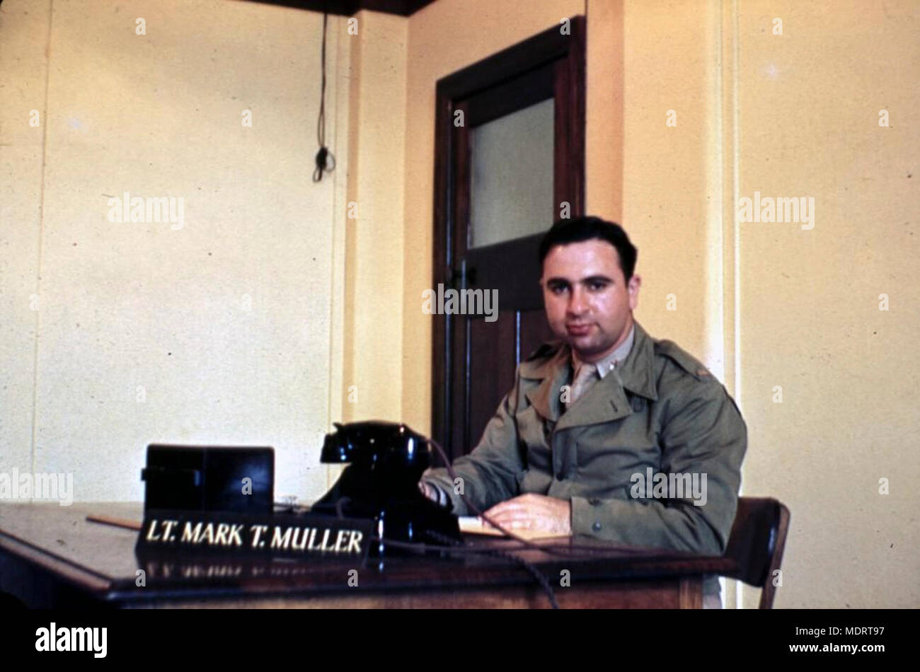 American Lieutenant Mark T Muller, assistant signal officer, behind his ...