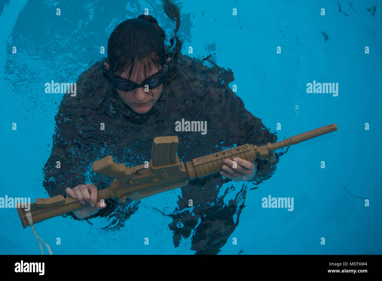Cpl. Alexandra Weir carries a rifle during the water tread portion of a ...