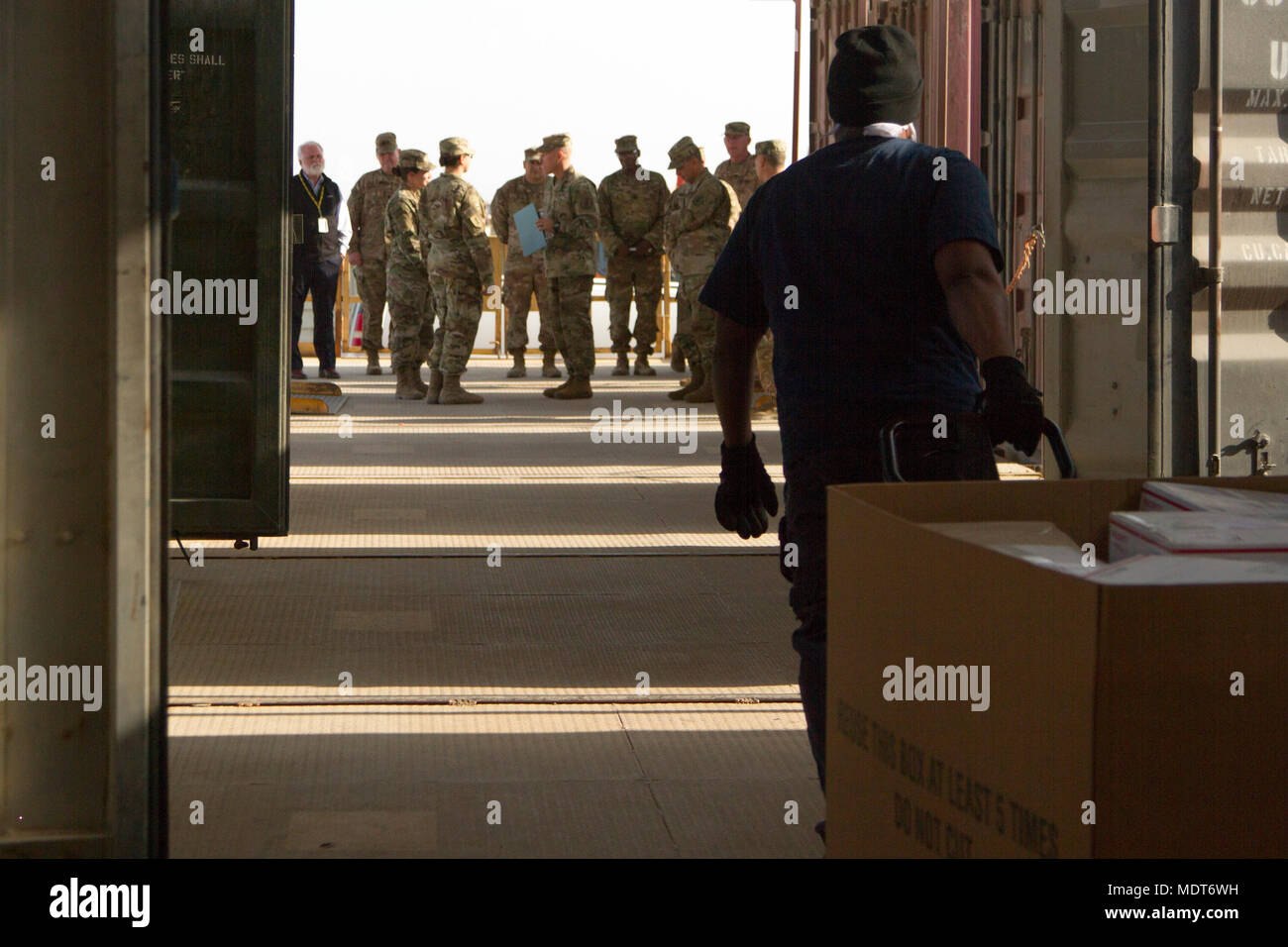 A contractor moves packages at the Joint Military Mail Terminal, Camp ...