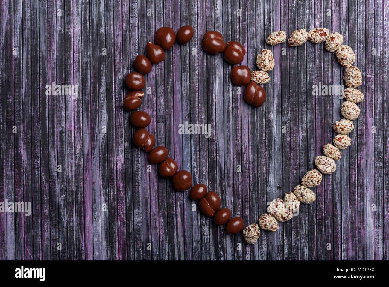Peanuts in chocolate. Peanut with caramel and sesame seeds. Sweet ...