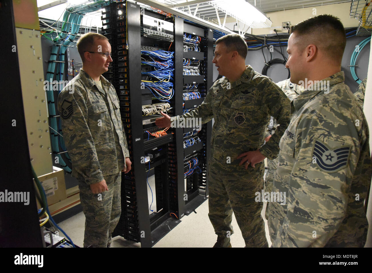 Col. Britt Hatley, the 119th Wing commander, center, discusses computer ...