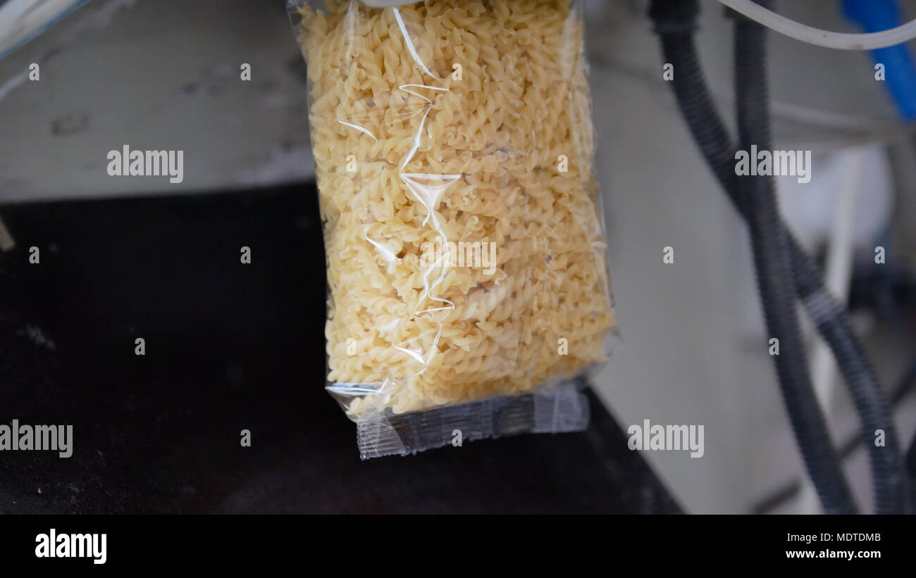 Food industry - packing of macaroni in plastic bags Stock Photo - Alamy