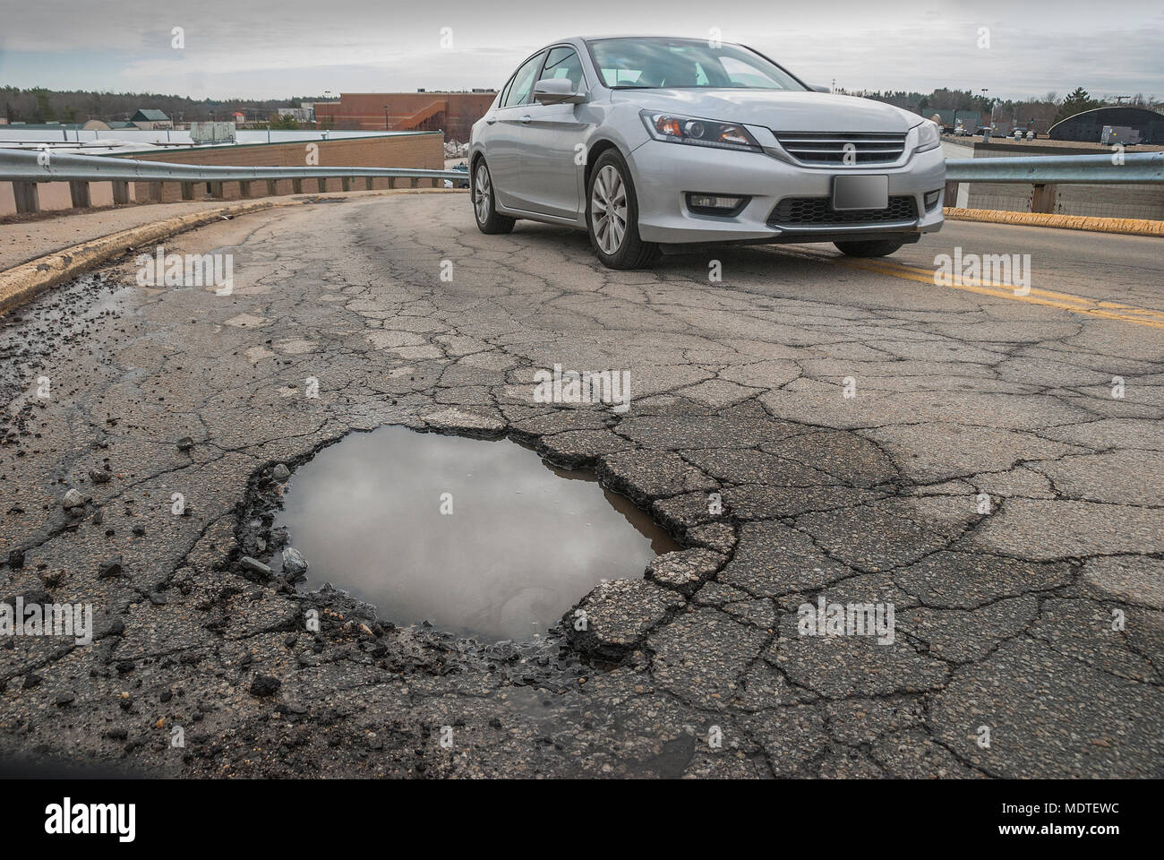 Pothole in road with broken asphalt after spring thaw Stock Photo - Alamy