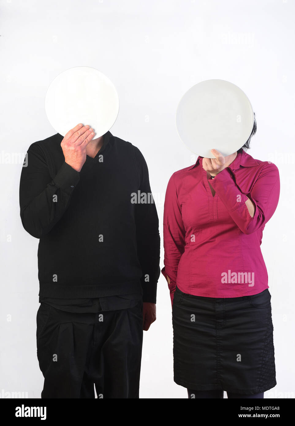 a couple with dishes in the face Stock Photo - Alamy