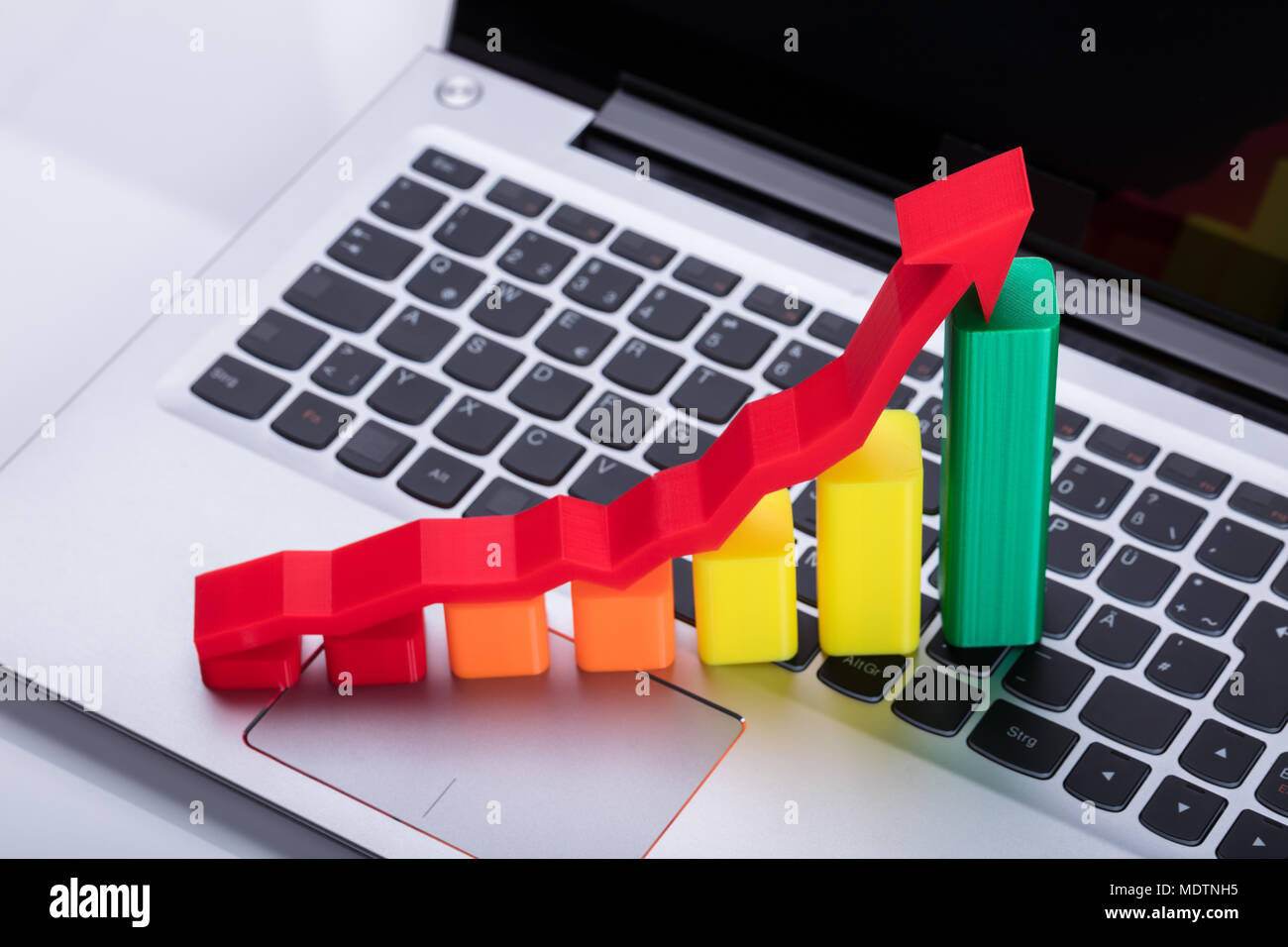 Close-up Of Graph And Arrow Sign Showing Upward Direction On Computer ...