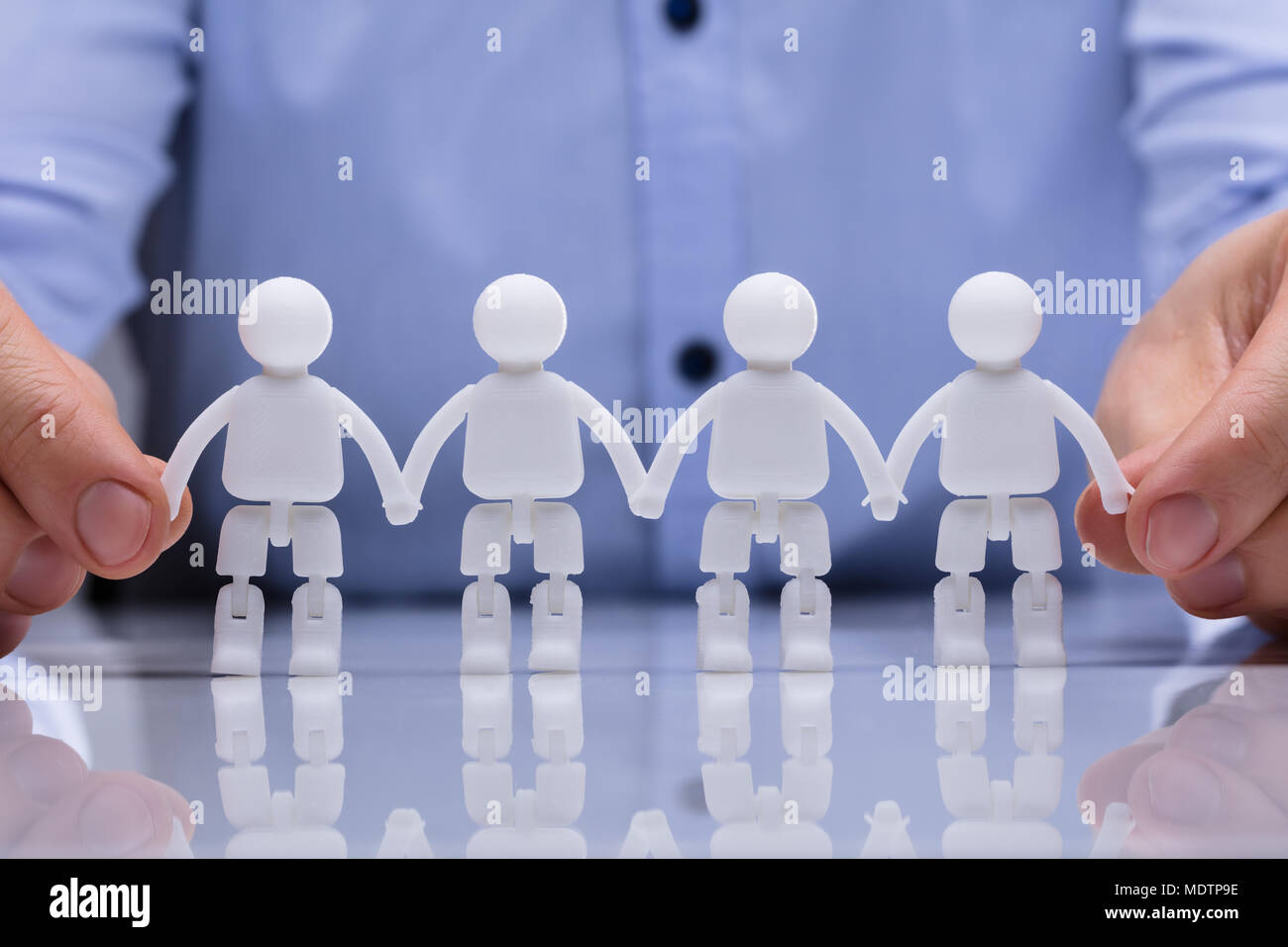 A Person's Hand Holding Human Figure's Hand Arranged In A Row Stock ...