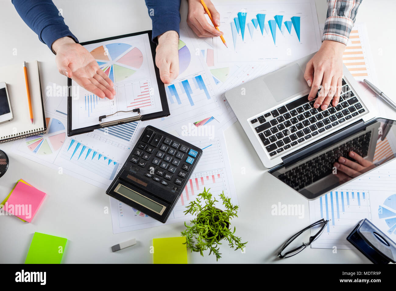 Business people discussing the charts and graphs showing the results of ...