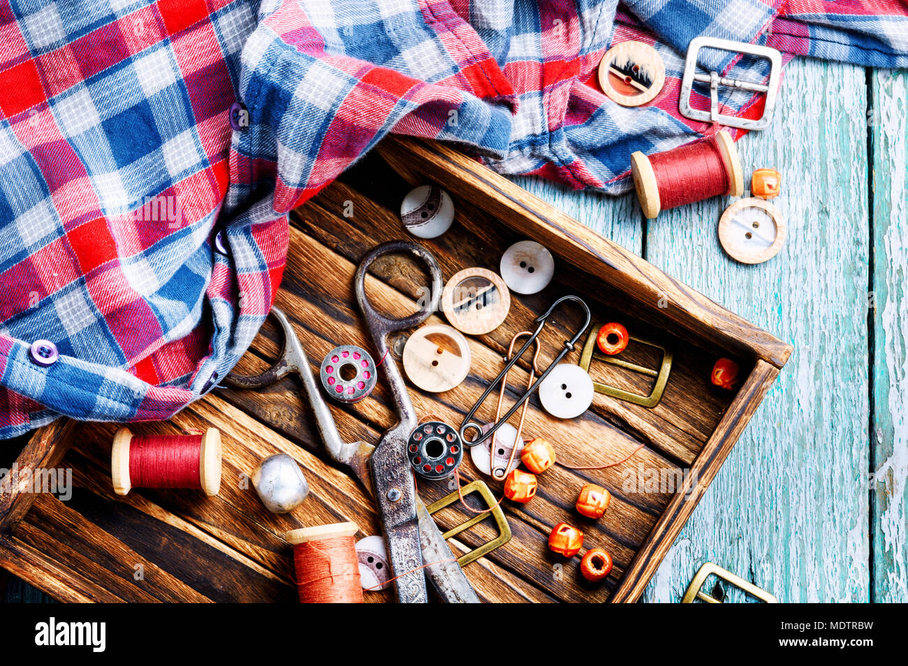 Wooden box with buttons from clothes, threads and scissors.Sewing ...