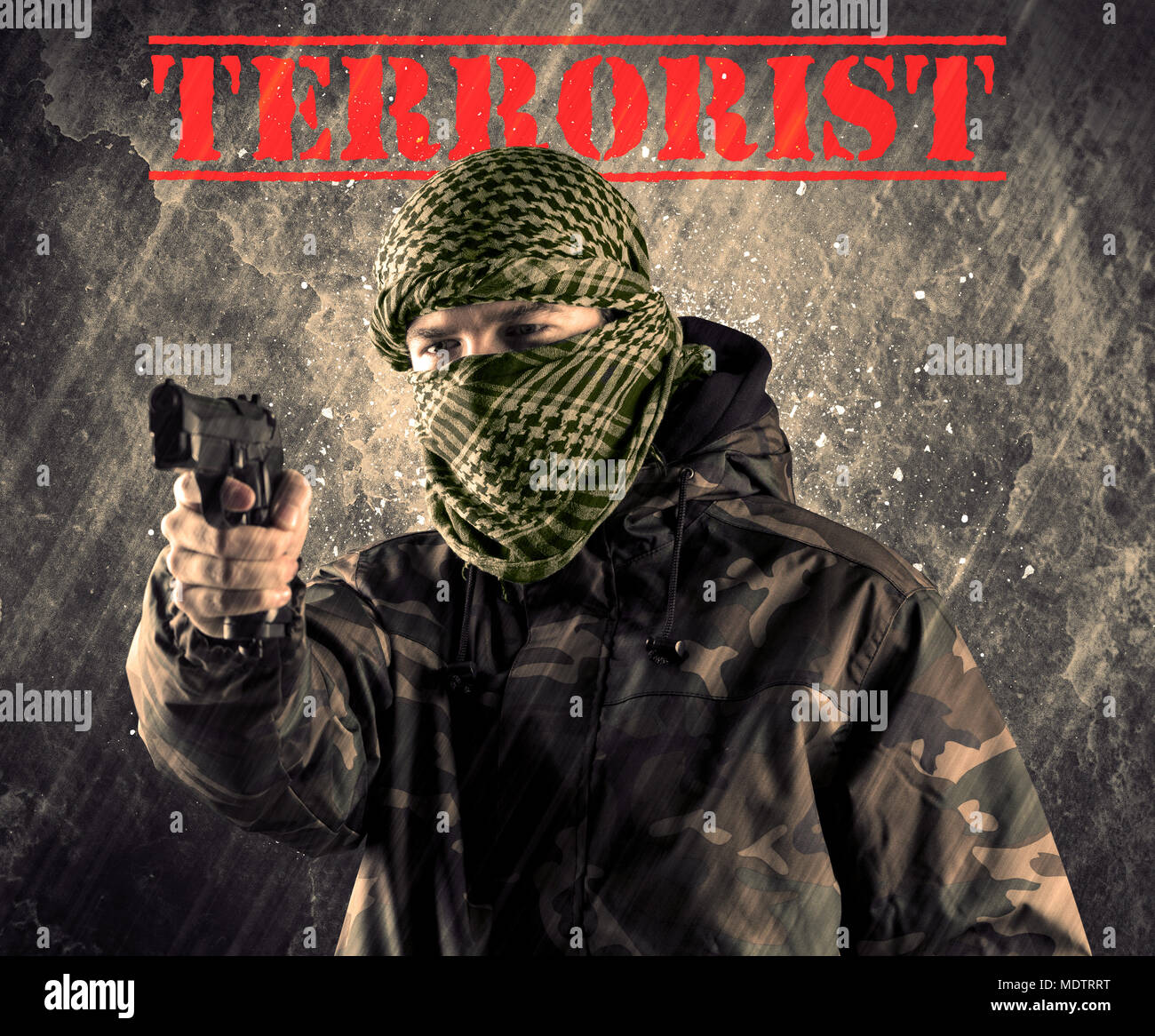 Portrait of dangerous masked and armed man with terrorist sign on ...