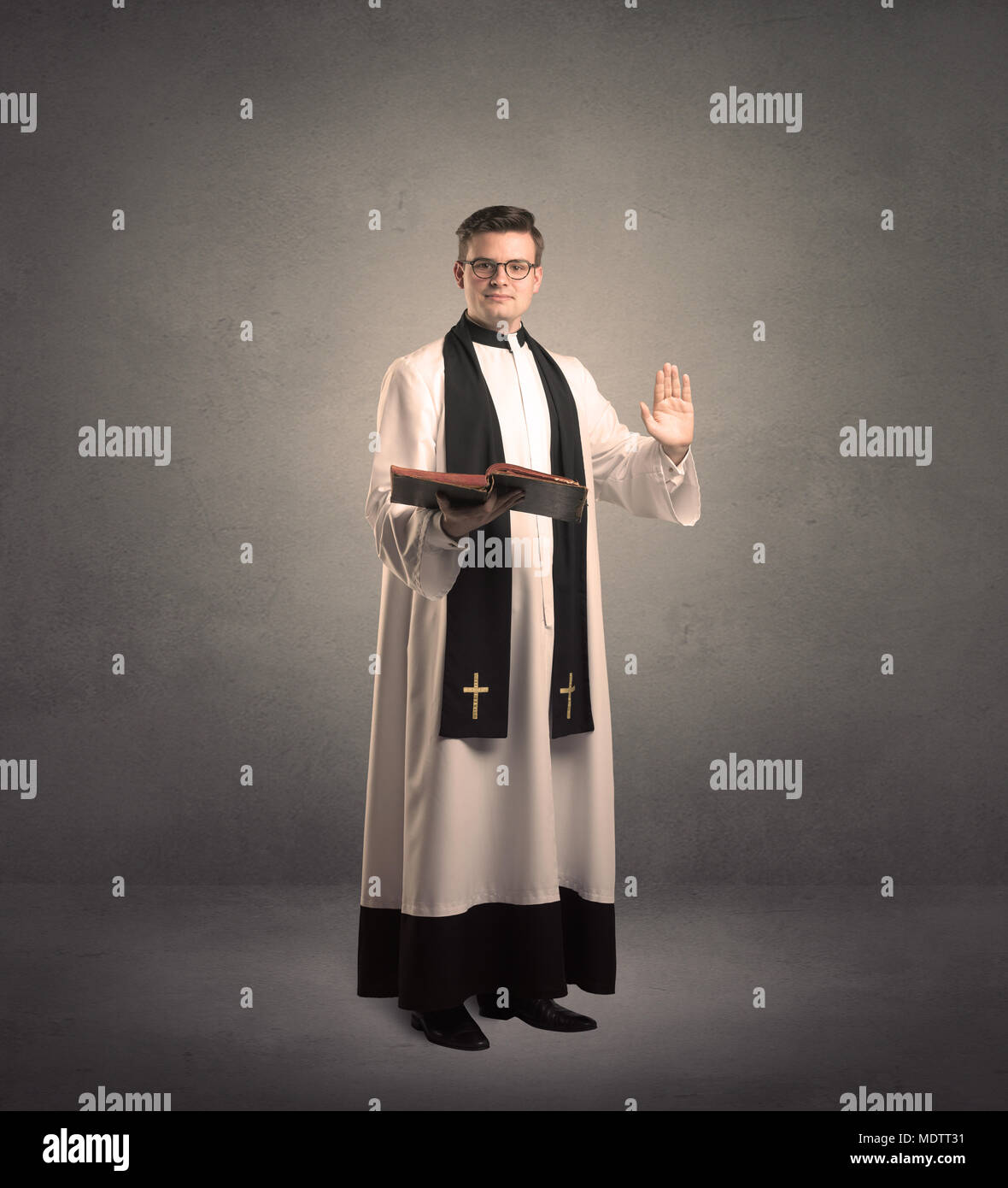 young priest in giving his blessing Stock Photo - Alamy