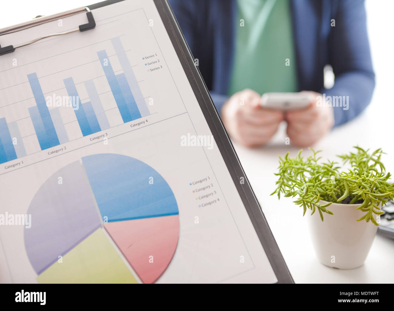 Closeup of a man checking accounts. Stock market chart and finger ...