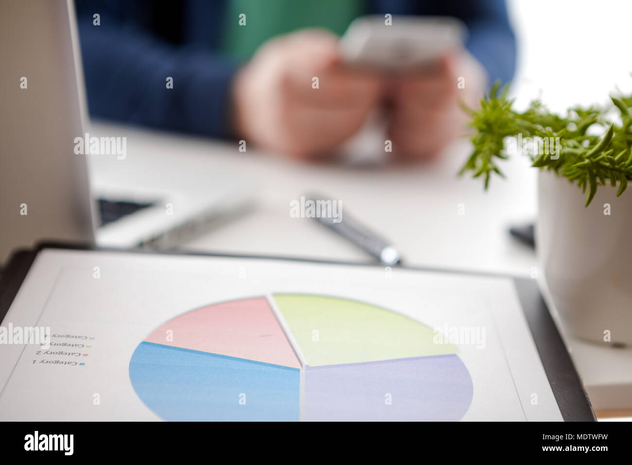 Closeup of a man checking accounts. Stock market chart and finger ...