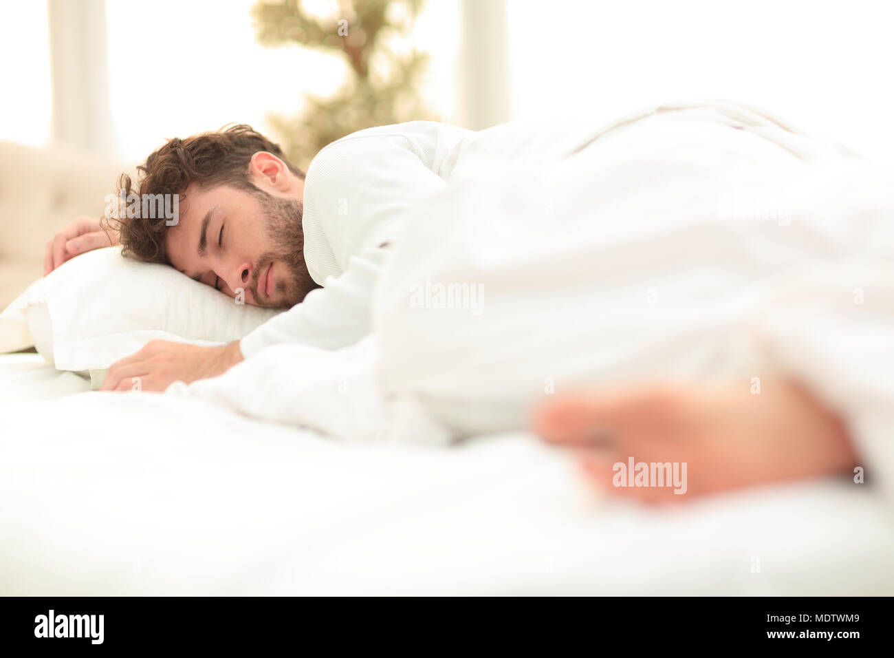 closeup.the tired men sleep soundly on the bed Stock Photo - Alamy