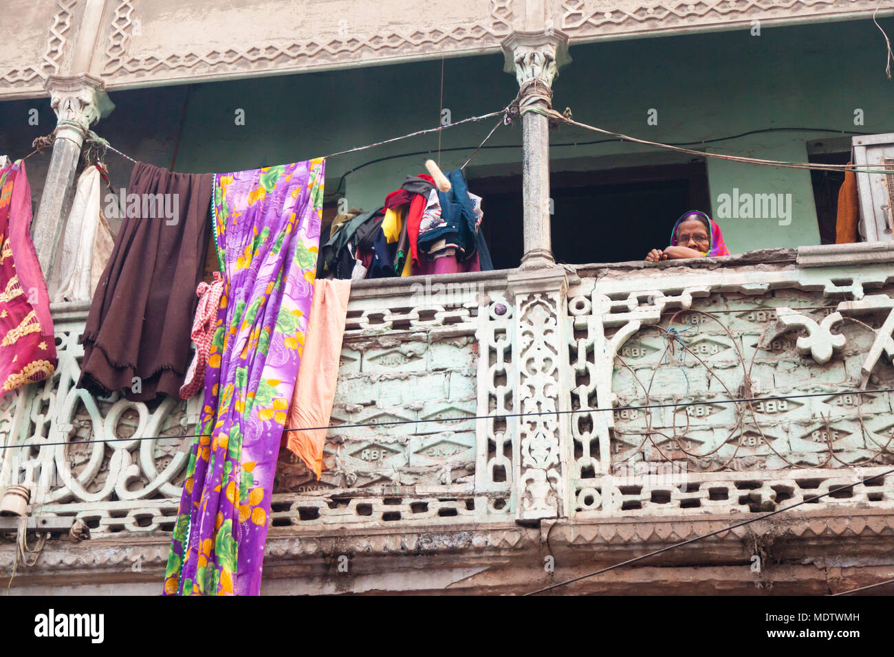 An elderly Lady watches the world go bye from above the street Stock ...