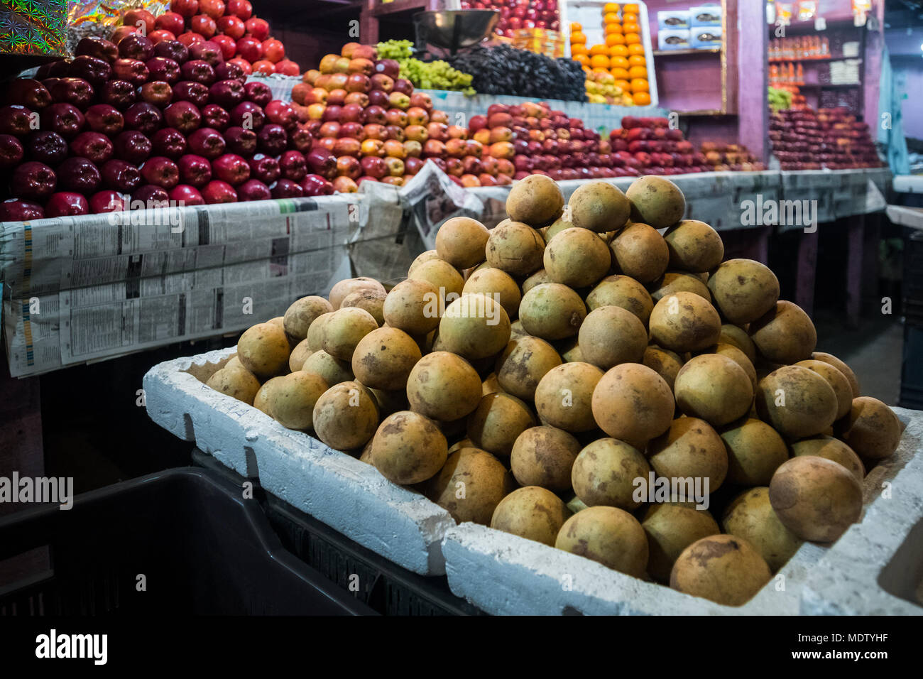 Ripe fruit on the street counter at the fruit market in India. Typical ...