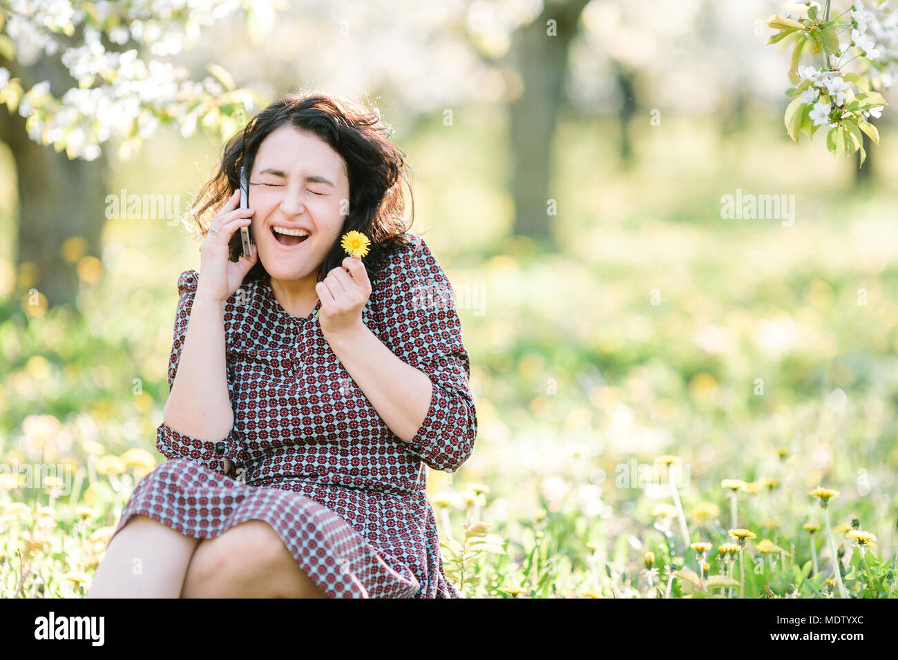 happiness, emotions, nature concept. in the middle of the dandelion ...