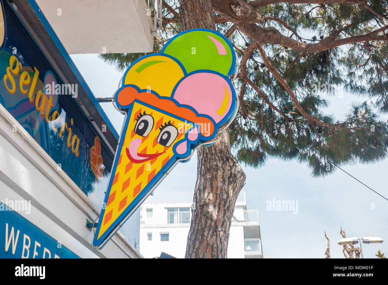 A sign attached to the outside of a shop selling ice cream Stock Photo ...