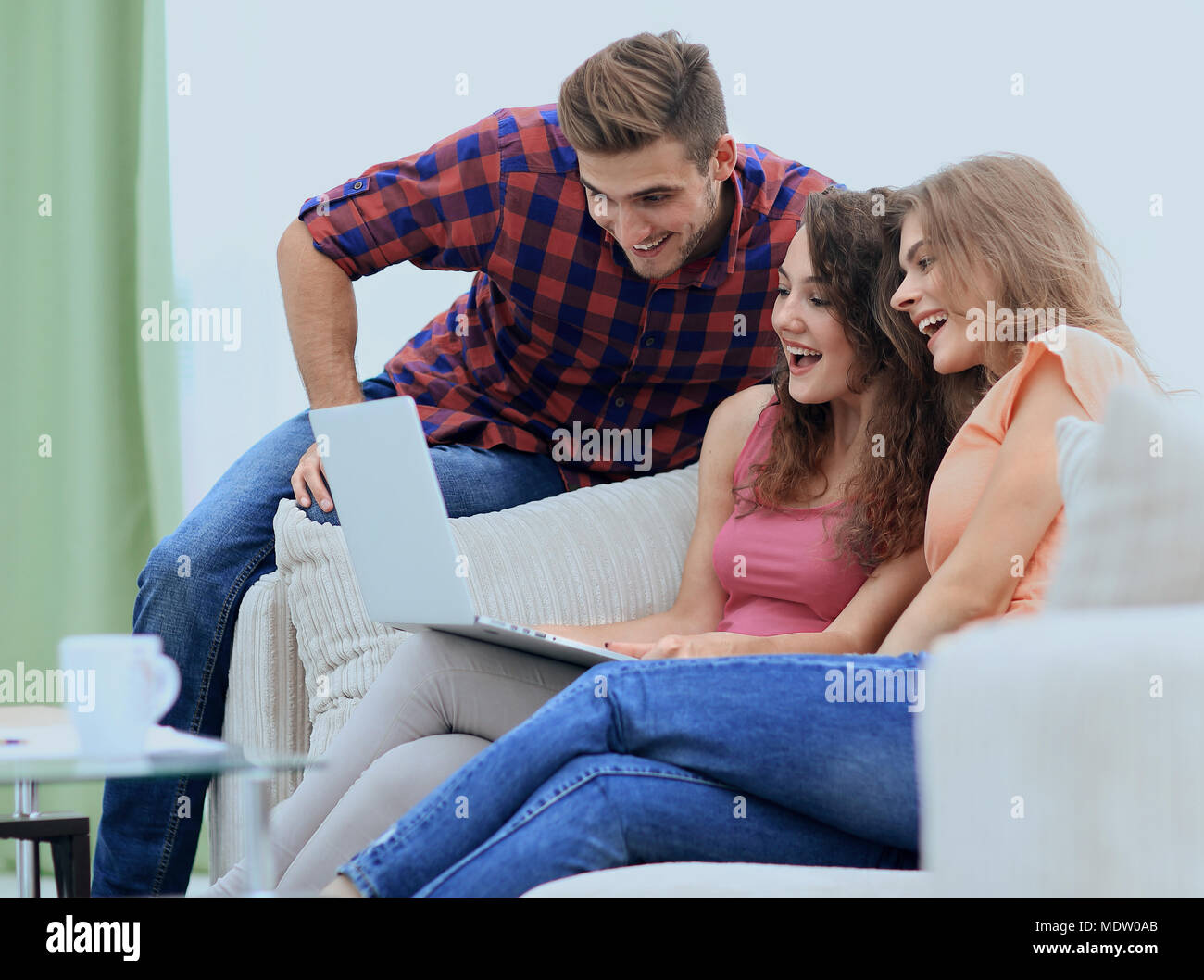 group of young people watching videos on the laptop Stock Photo - Alamy