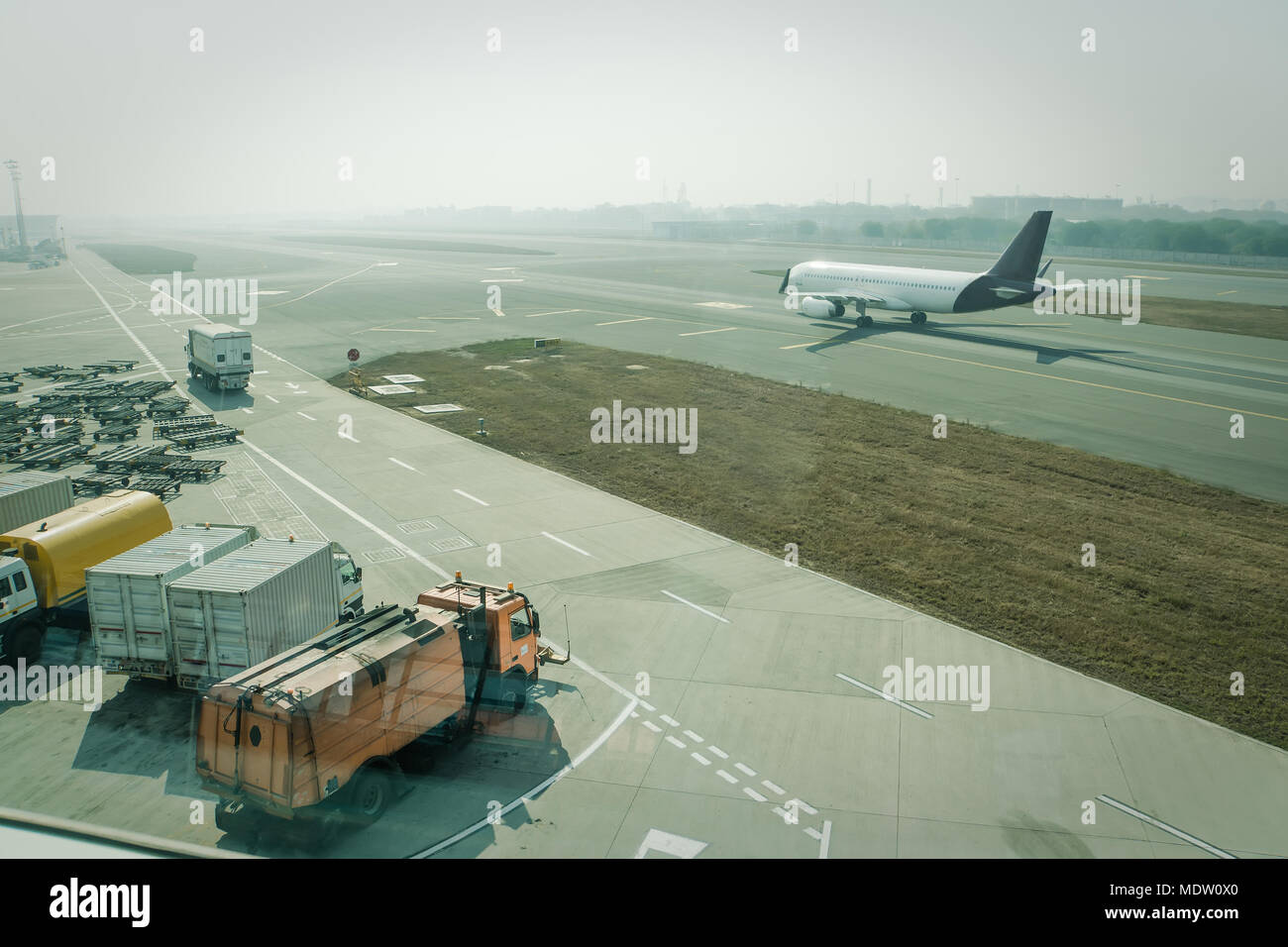 A passenger plane being serviced by ground services before next takeoff ...