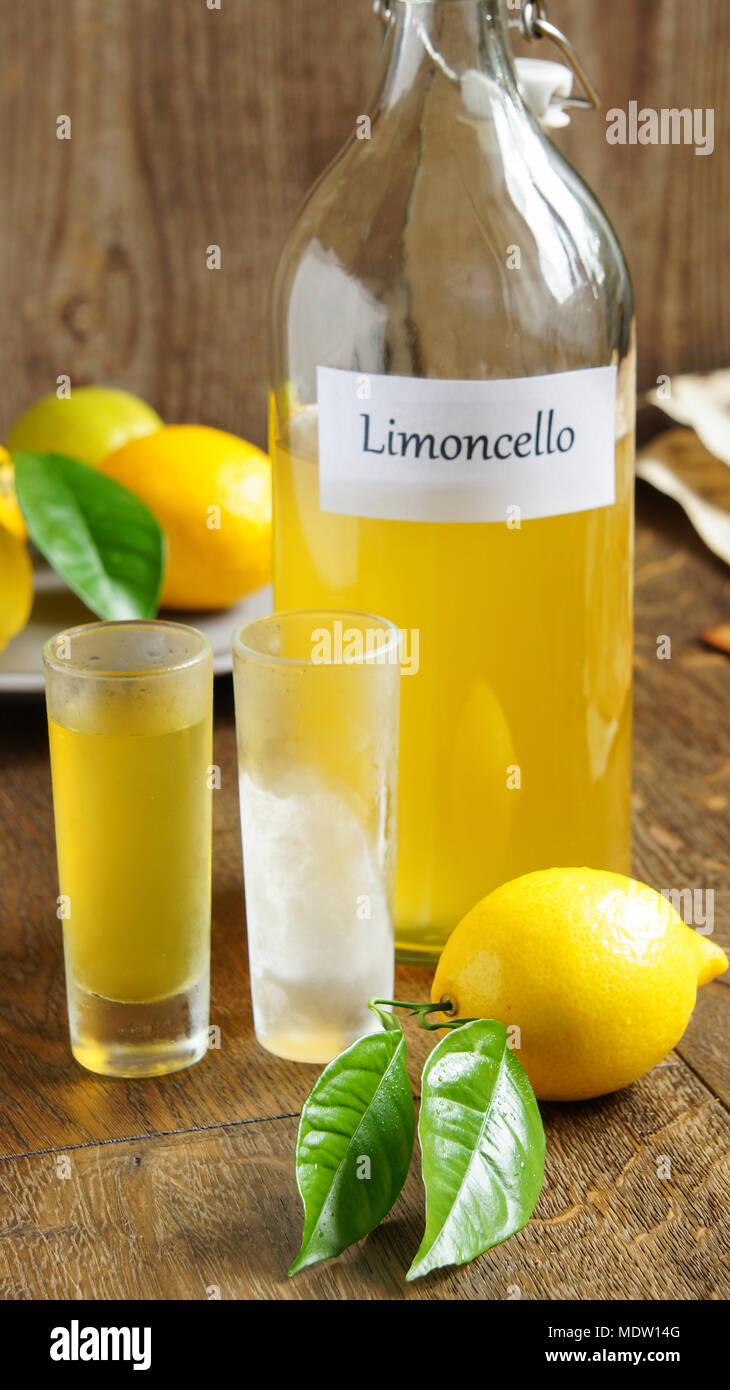 Italian alcoholic beverage, Limoncello on wooden table Stock Photo - Alamy
