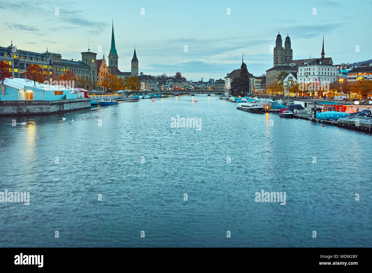 Sunset panorama of city of Zurich and reflection in Limmat River ...