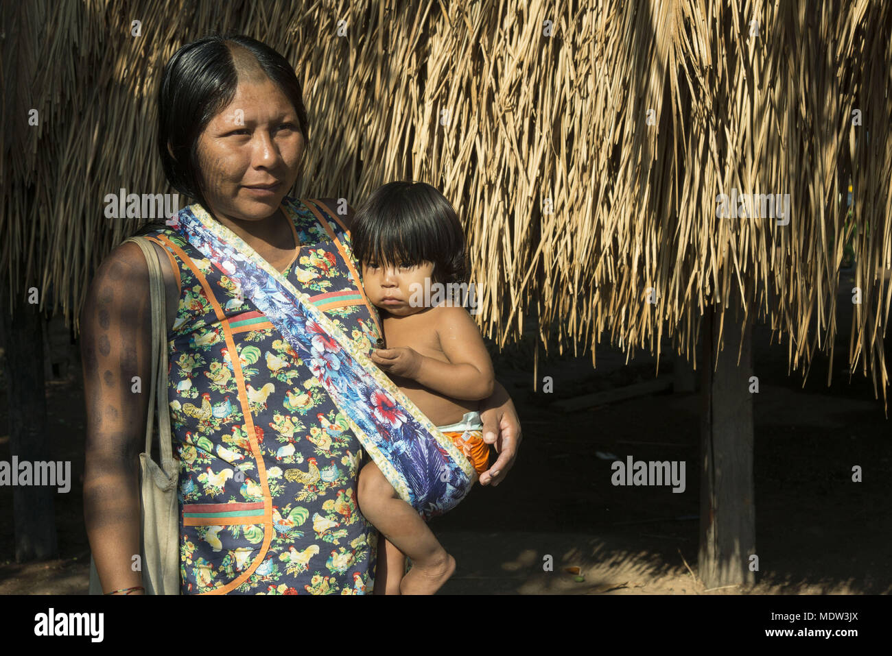 India Kayapo village of Moikarako with son on lap Stock Photo - Alamy