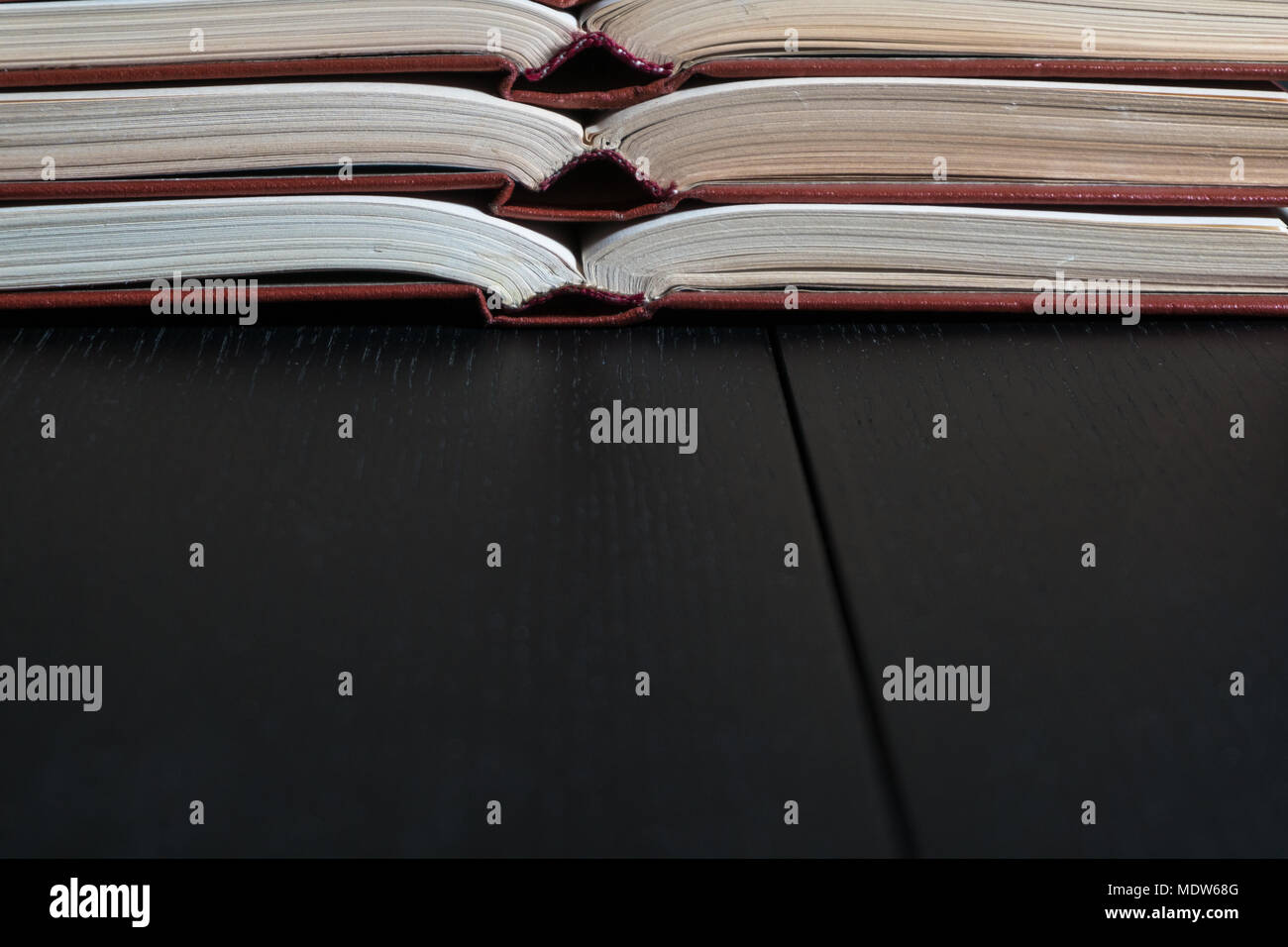 Open book hardback on Stack books Stock Photo - Alamy