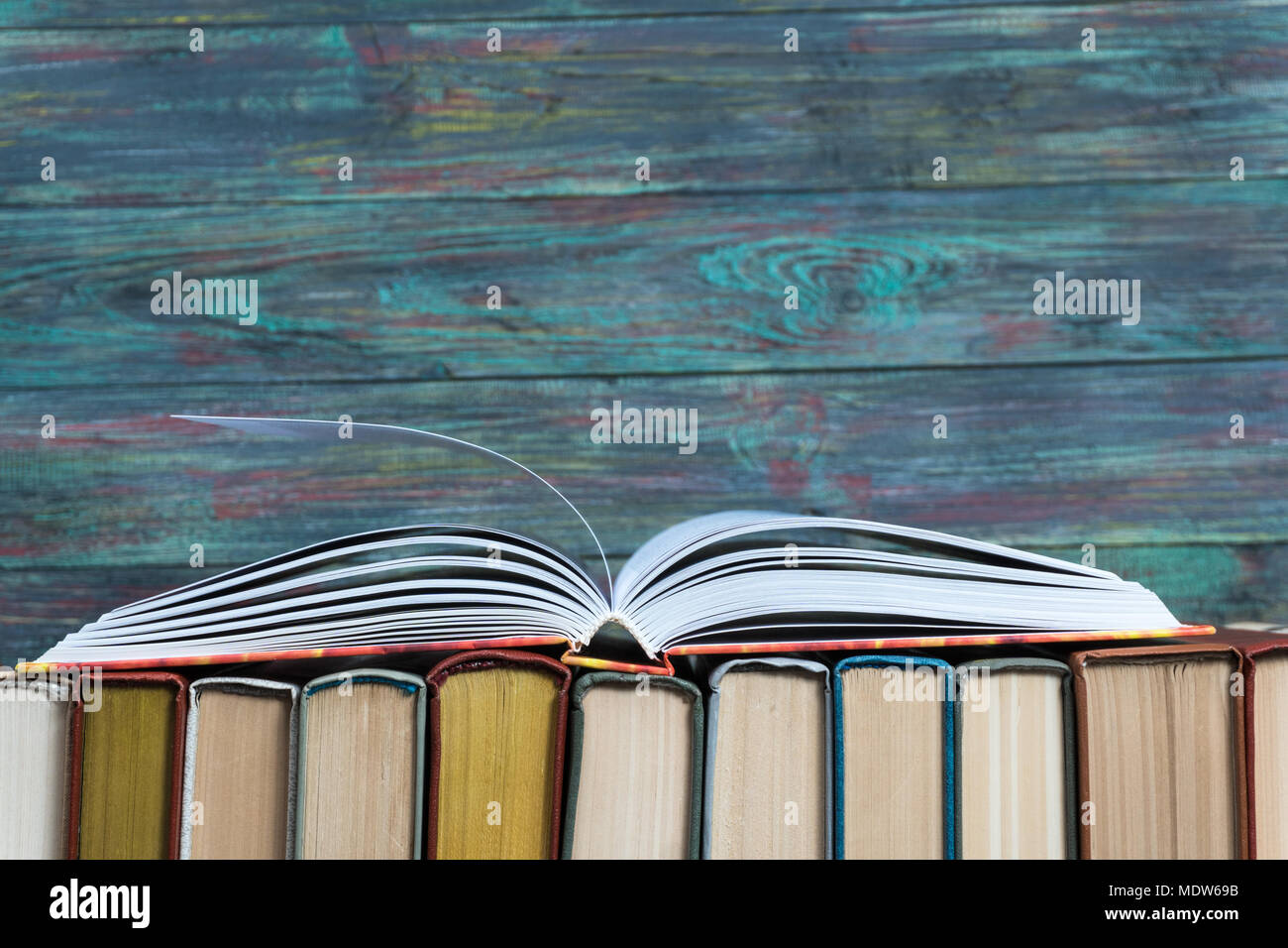 Open book hardback on Stack books Stock Photo - Alamy