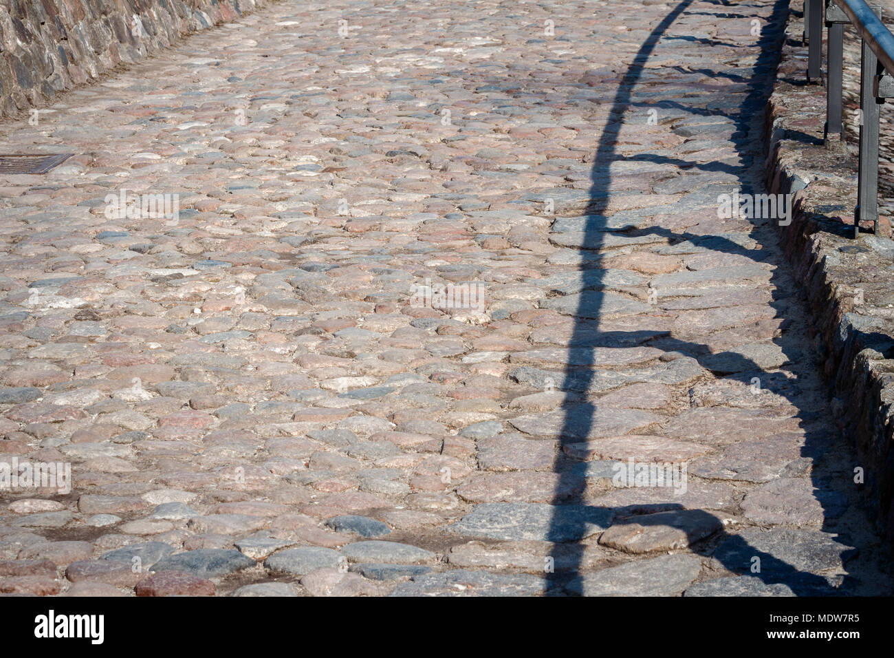 Stone pavement and railing shadow Stock Photo - Alamy