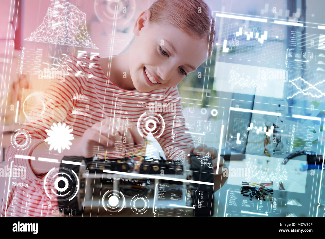 Attentive child smiling while leaning to an unfinished robot Stock ...