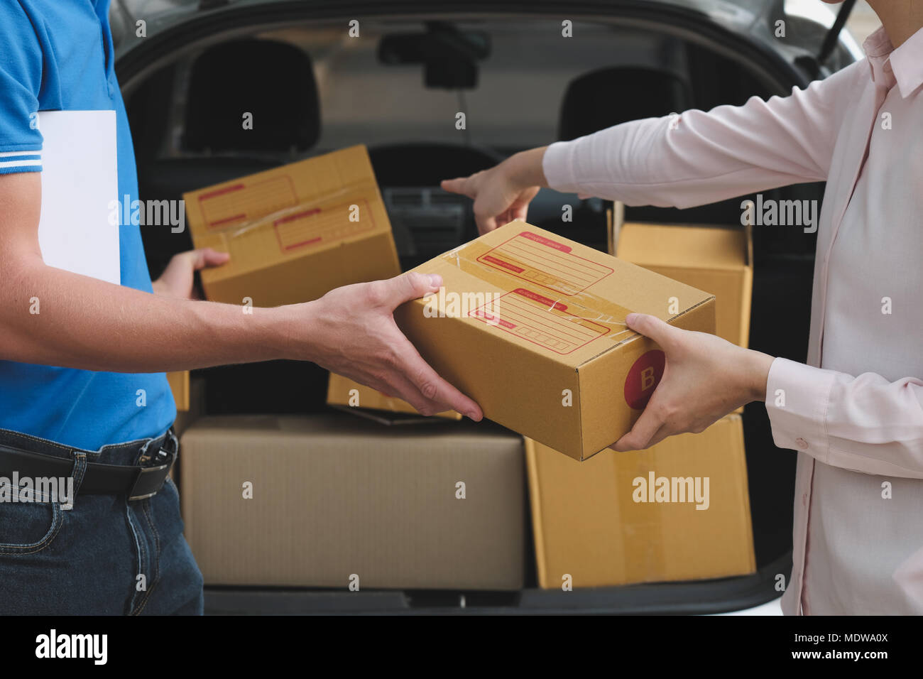 woman receive package from delivery man. male postal courier person ...