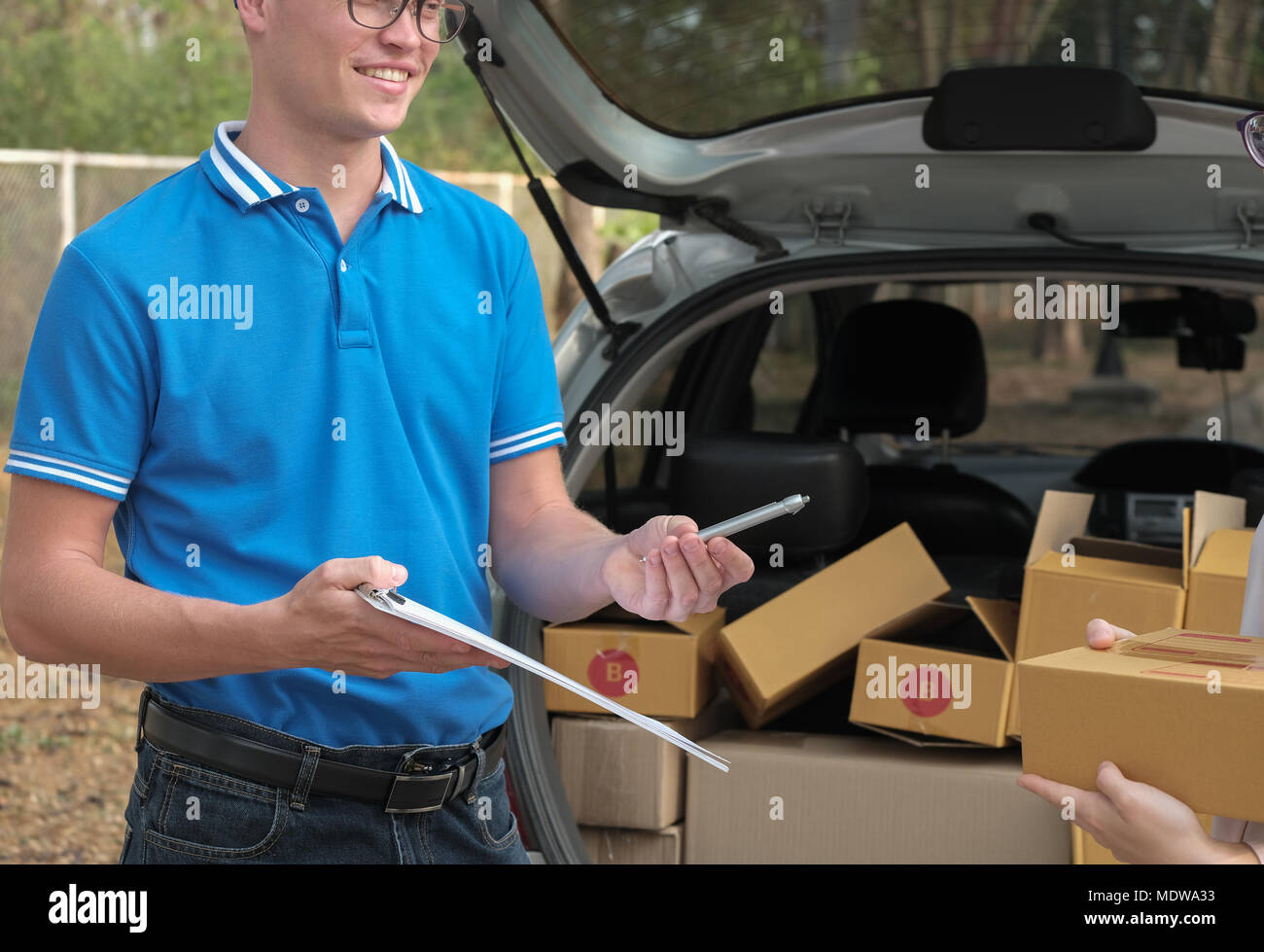 woman receive package from delivery man. male postal courier person ...