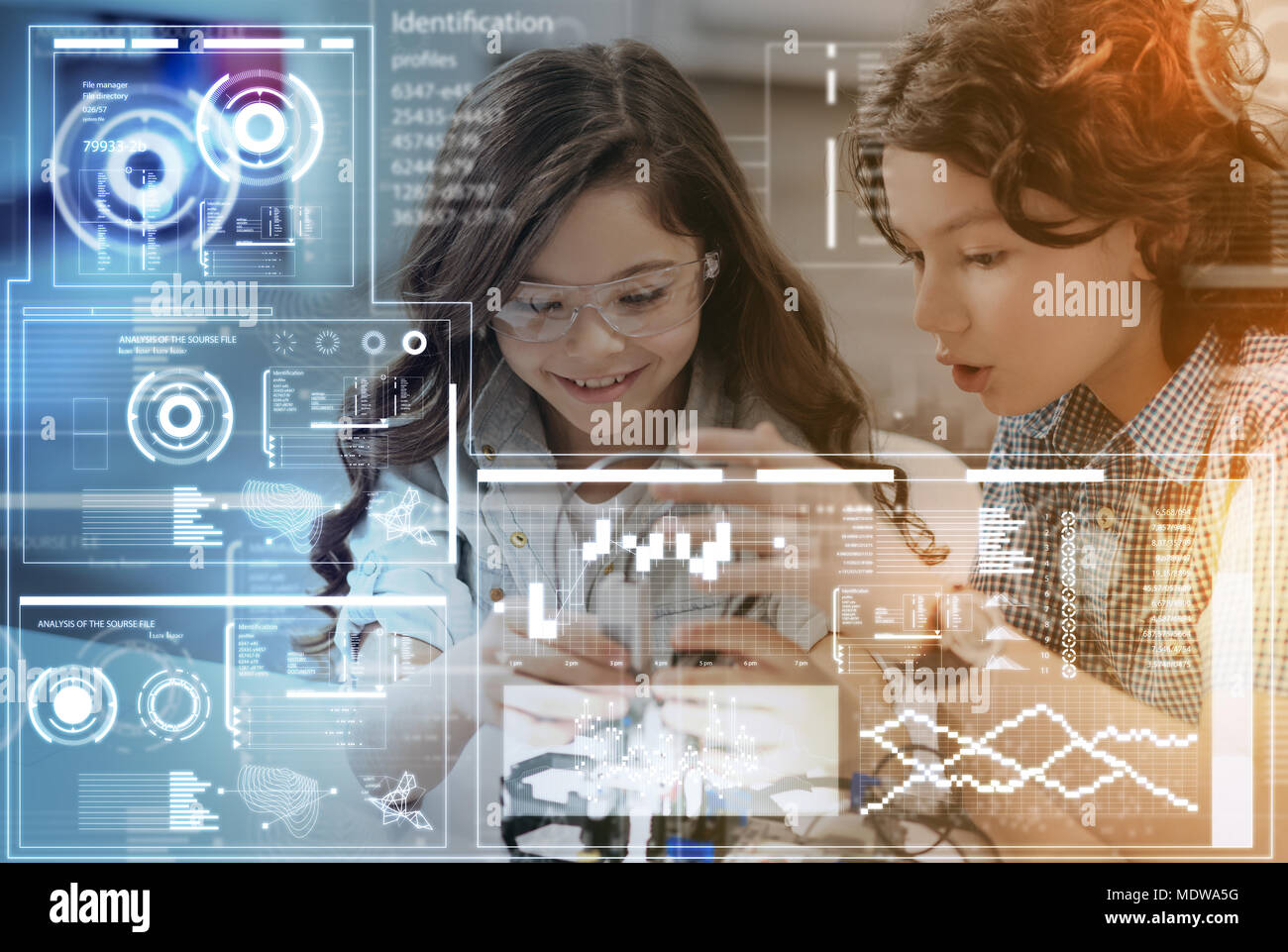 Little girl smiling while her friend looking surprised Stock Photo - Alamy