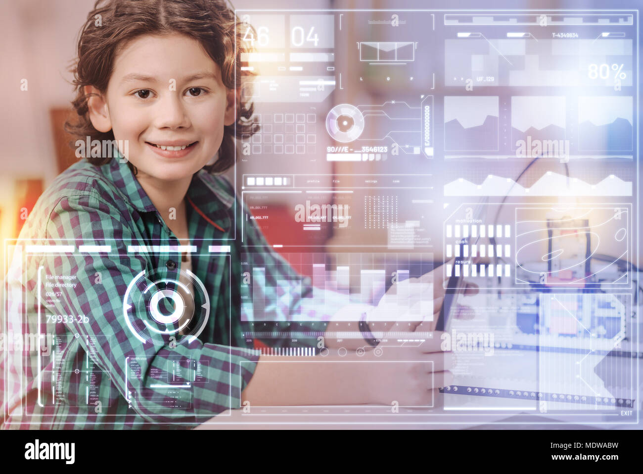 Smiling boy feeling glad while sitting at the interesting lesson Stock ...