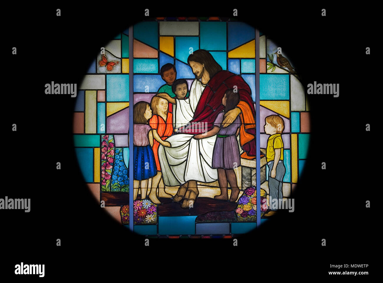 Jesus with children in round stained glass Stock Photo - Alamy