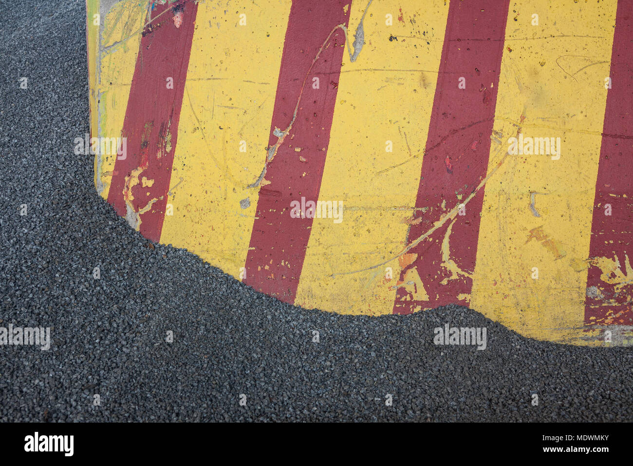 Worn concrete roadblock in gravel Stock Photo - Alamy